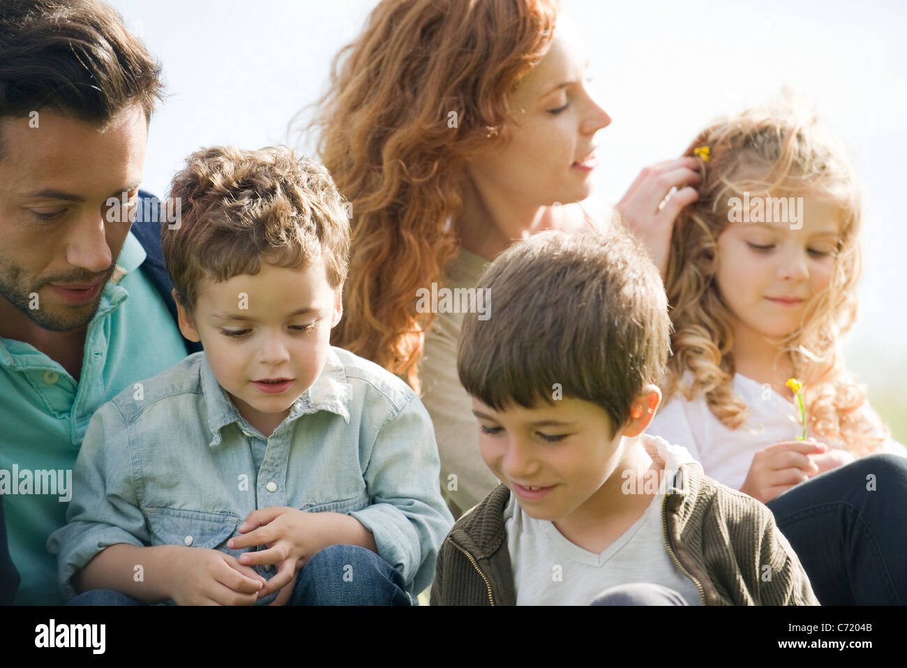 Family relaxing together outdoors Stock Photo - Alamy