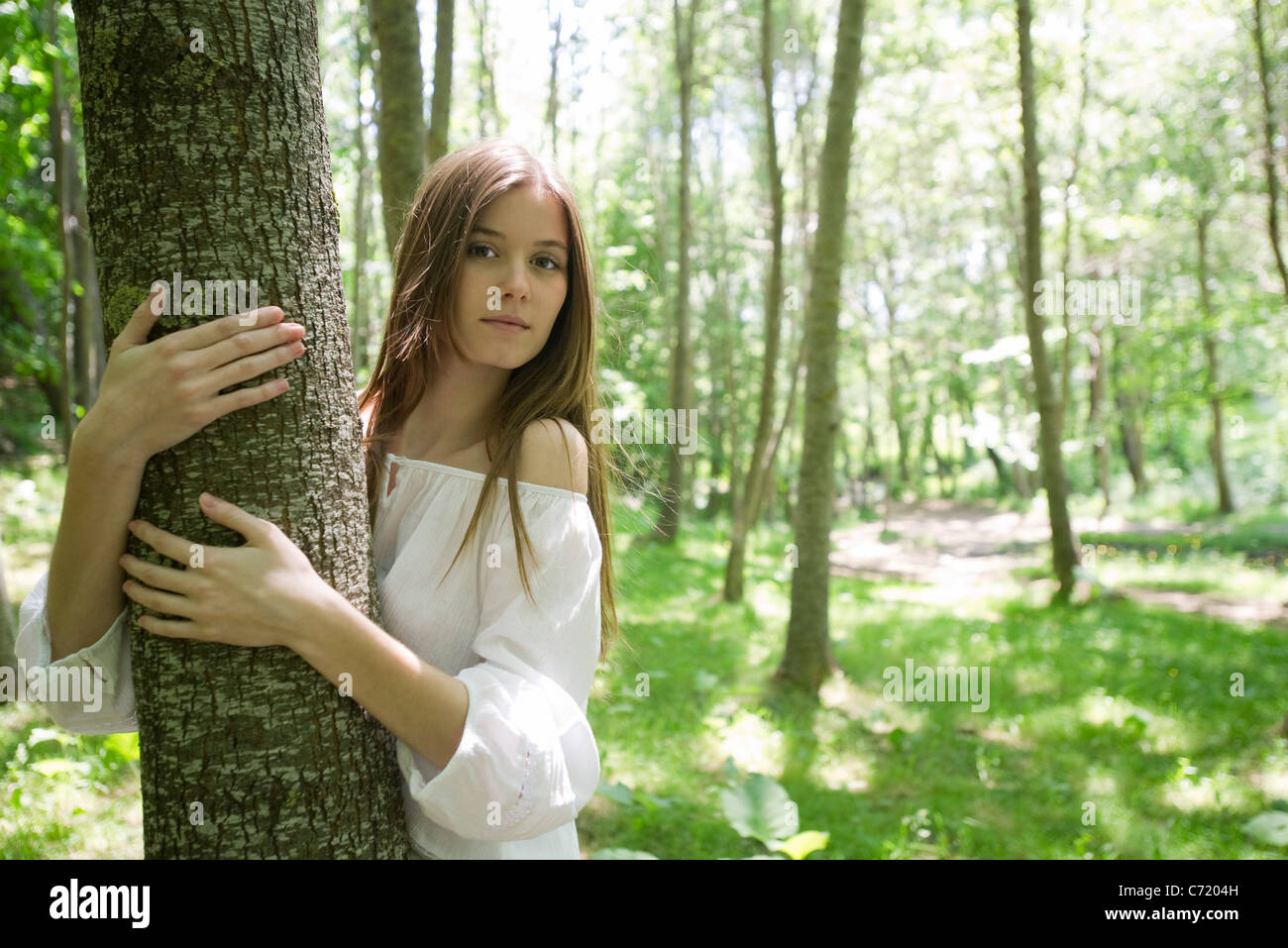 Young woman hugging tree, portrait Stock Photo - Alamy
