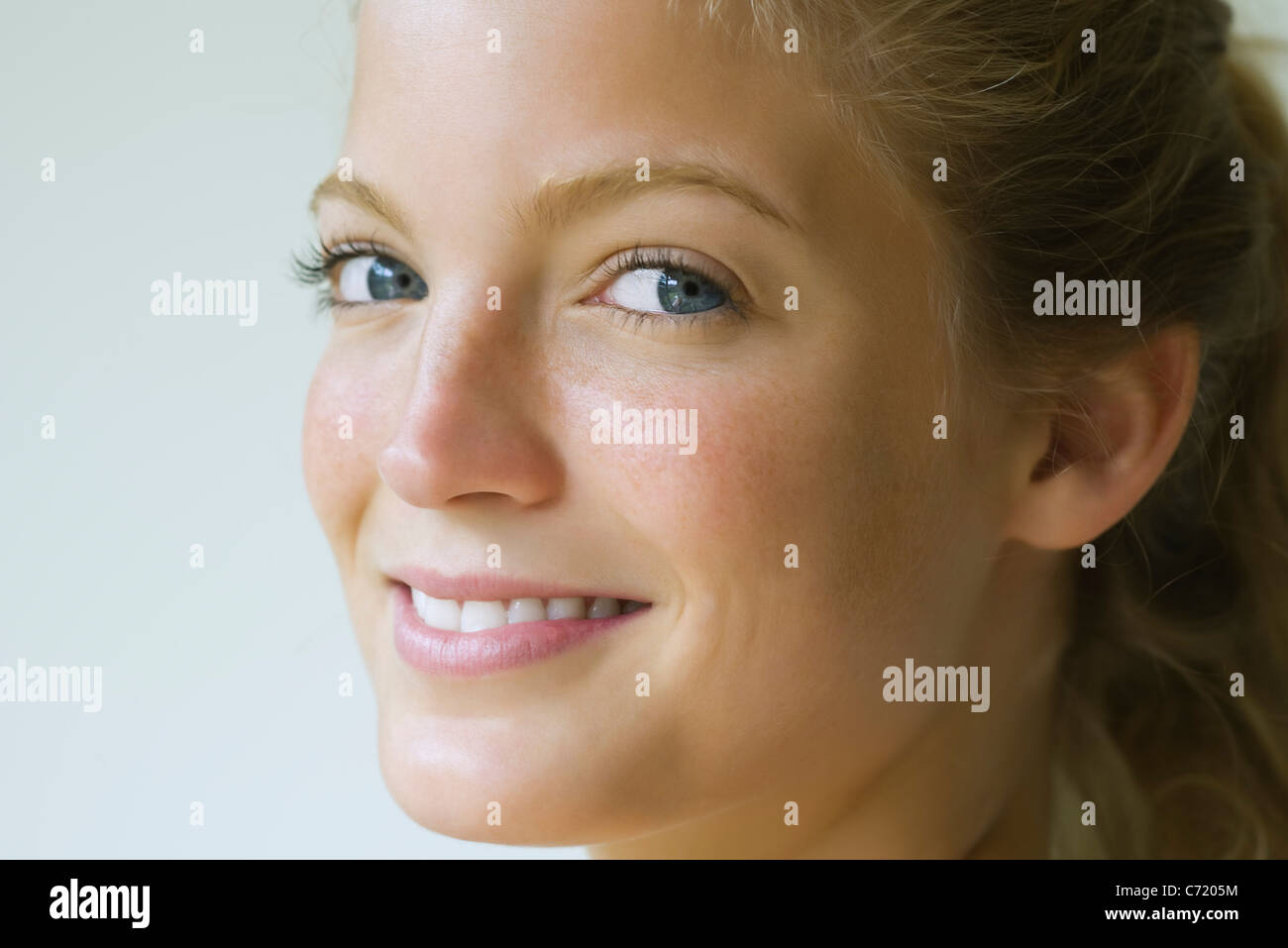 Young woman glancing sideways at camera, portrait Stock Photo - Alamy