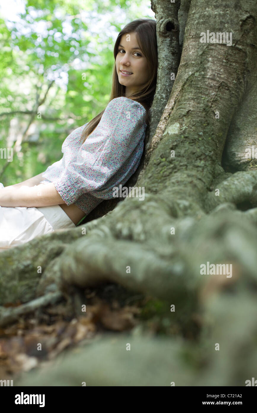 Woman Sitting Against Tree Trunk High Resolution Stock Photography and ...