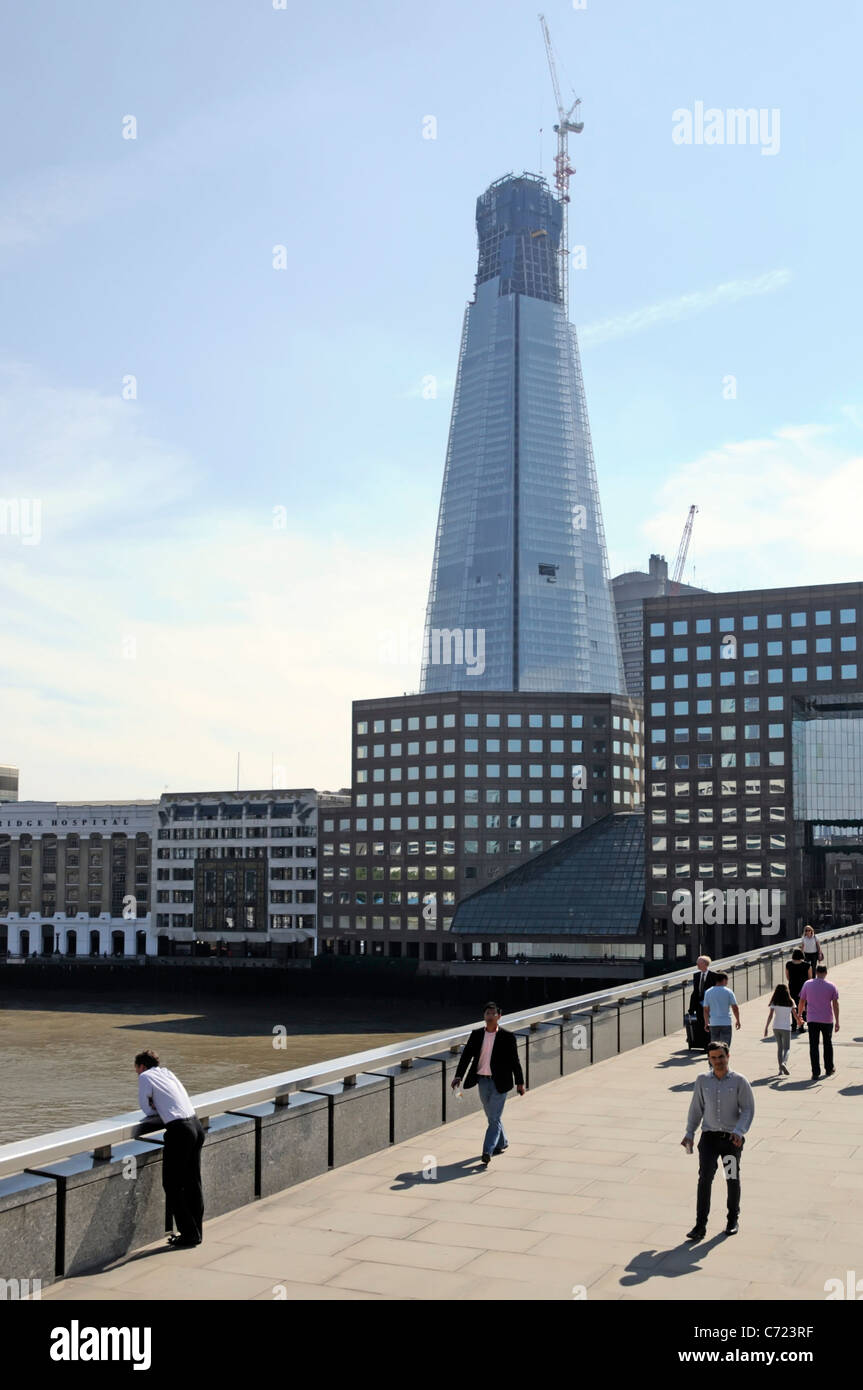 London Bridge pavement with pedestrians and the Shard building under ...