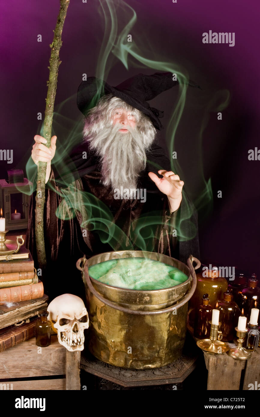 Evil sorcerer casting a spell on green poison soup Stock Photo - Alamy
