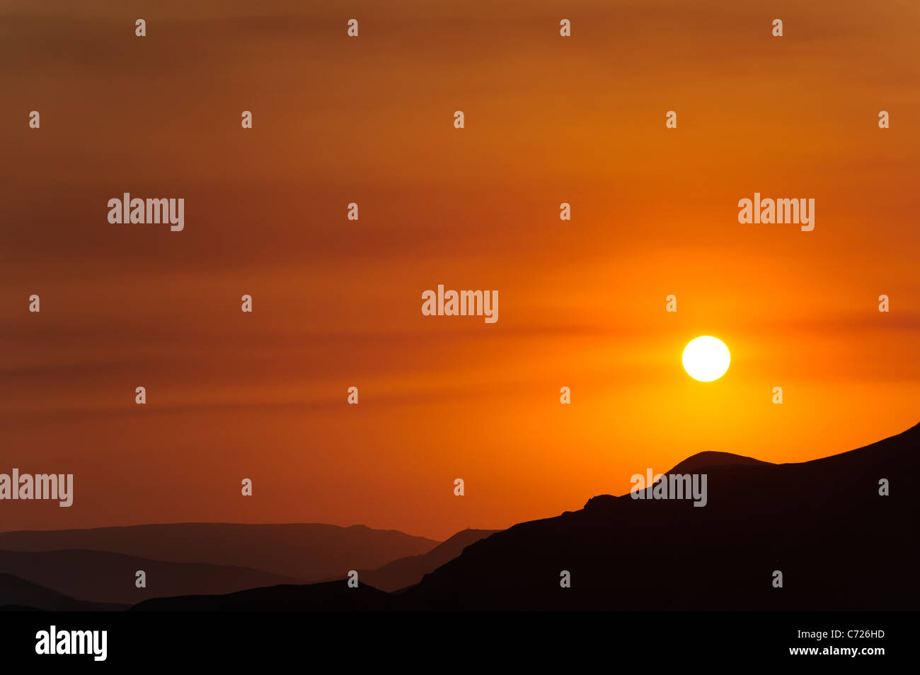 Colourful decline over mountains. Red colour Stock Photo - Alamy