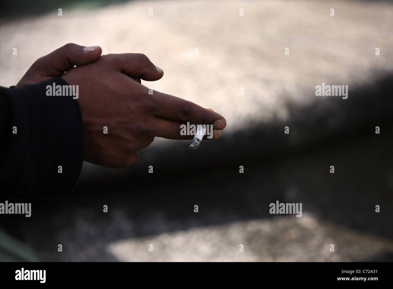 Hand lighted cigarette smoke hi-res stock photography and images - Alamy