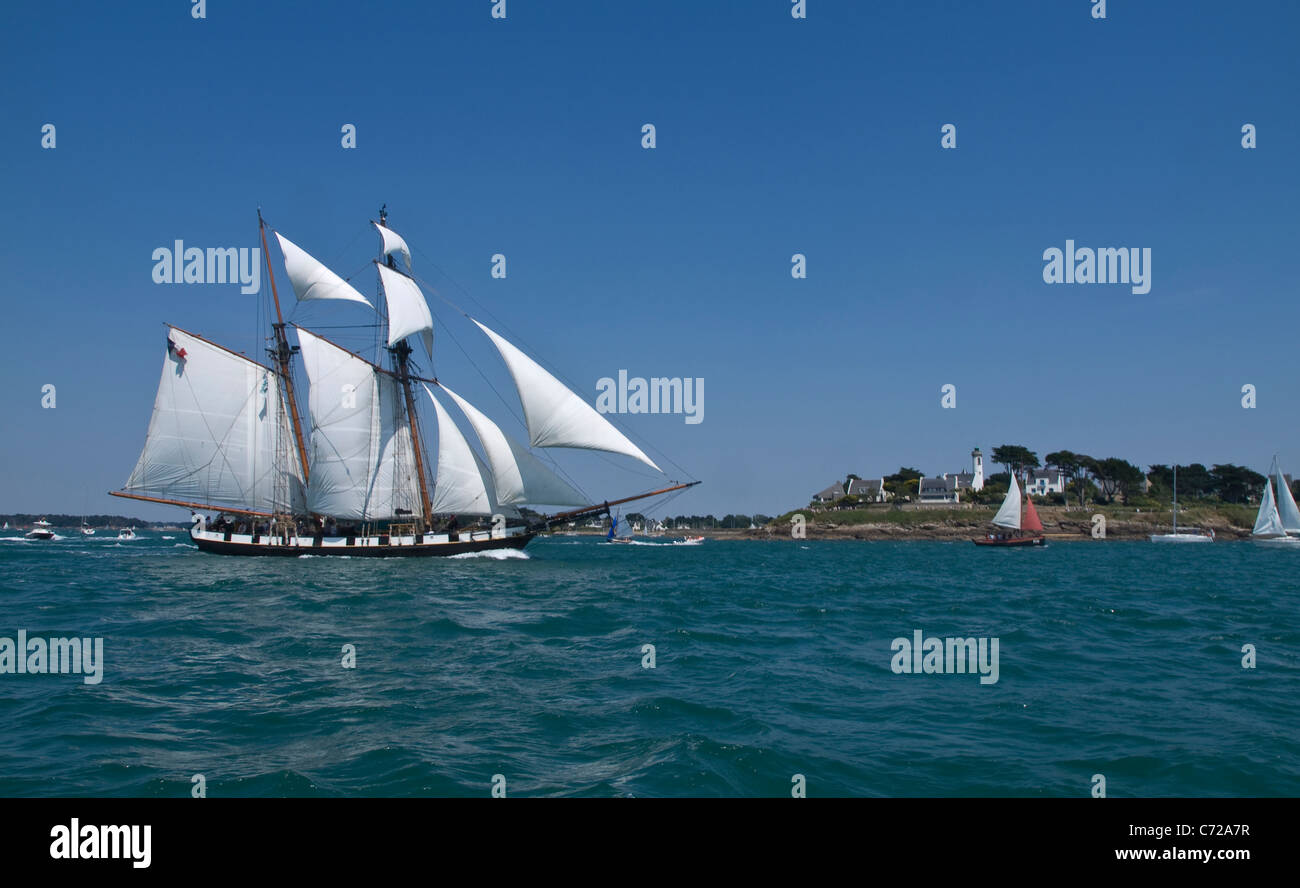 Ancient schooner sailing near a lighthouse, Bay of Morbihan, Birttany ...