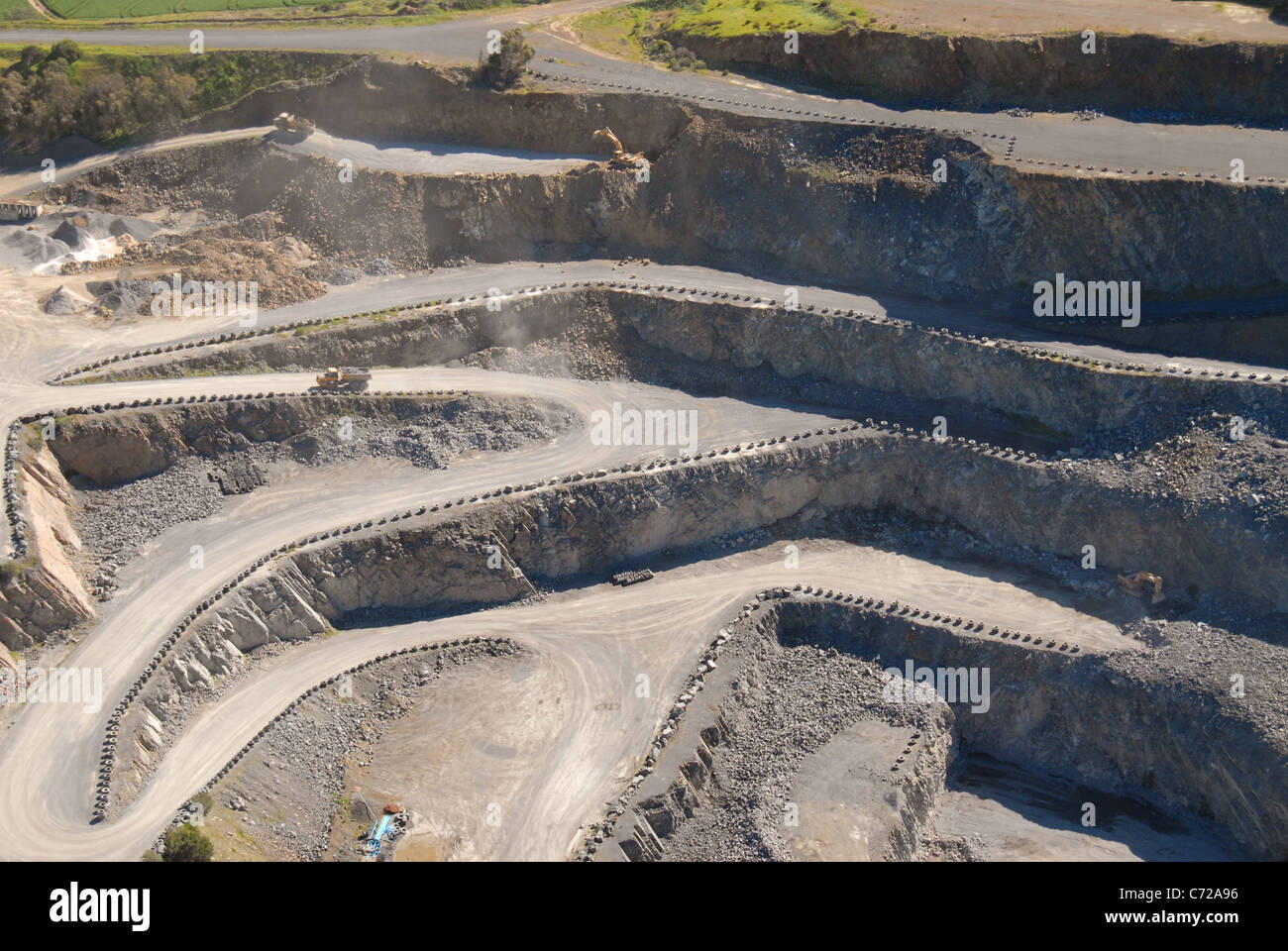Earth movers working in an open cast mine Stock Photo - Alamy
