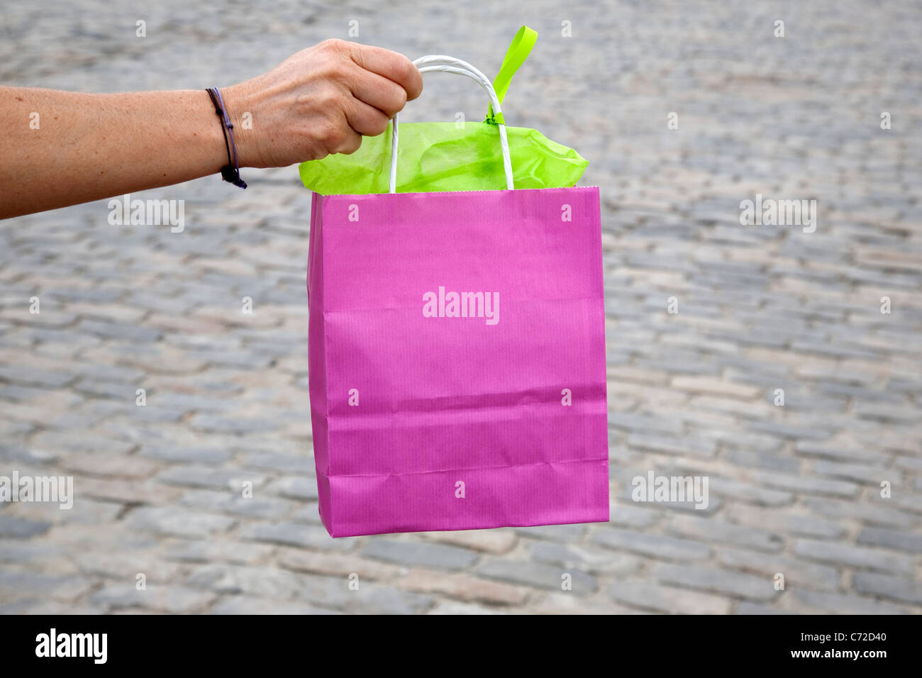 Pink Shopping Bag Held by a Woman Stock Photo - Alamy