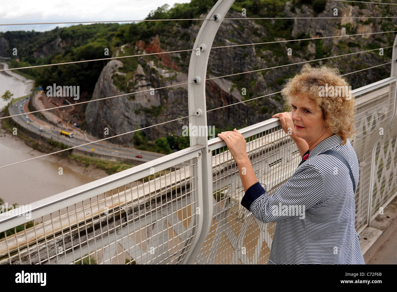 Woman scared of heights looks worried on the Clifton Suspension Bridge ...