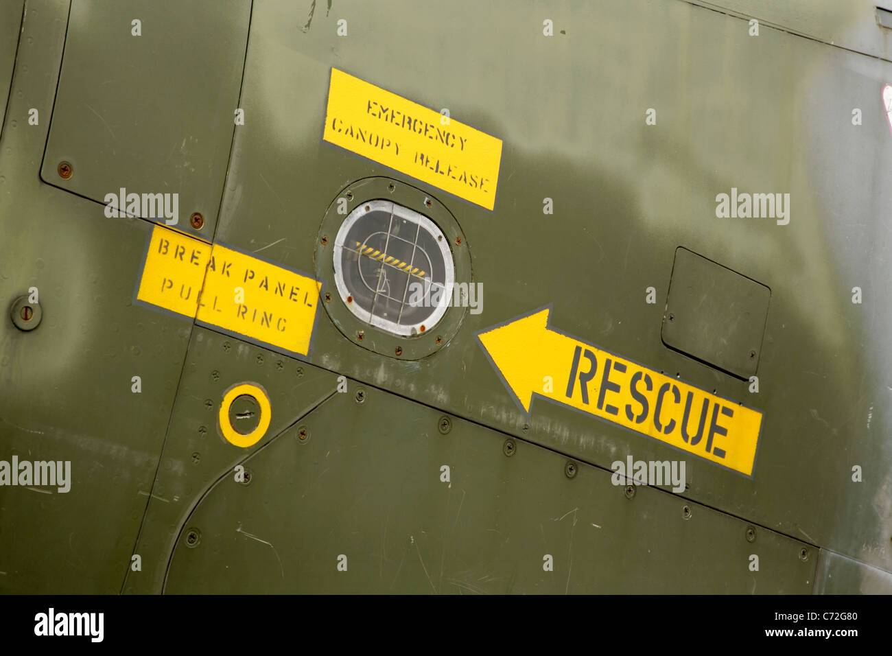 Yellow emergency signs and rescue direction arrow on side of military ...
