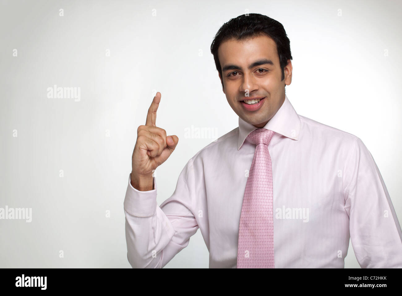 Portrait of a businessman making a hand gesture Stock Photo - Alamy