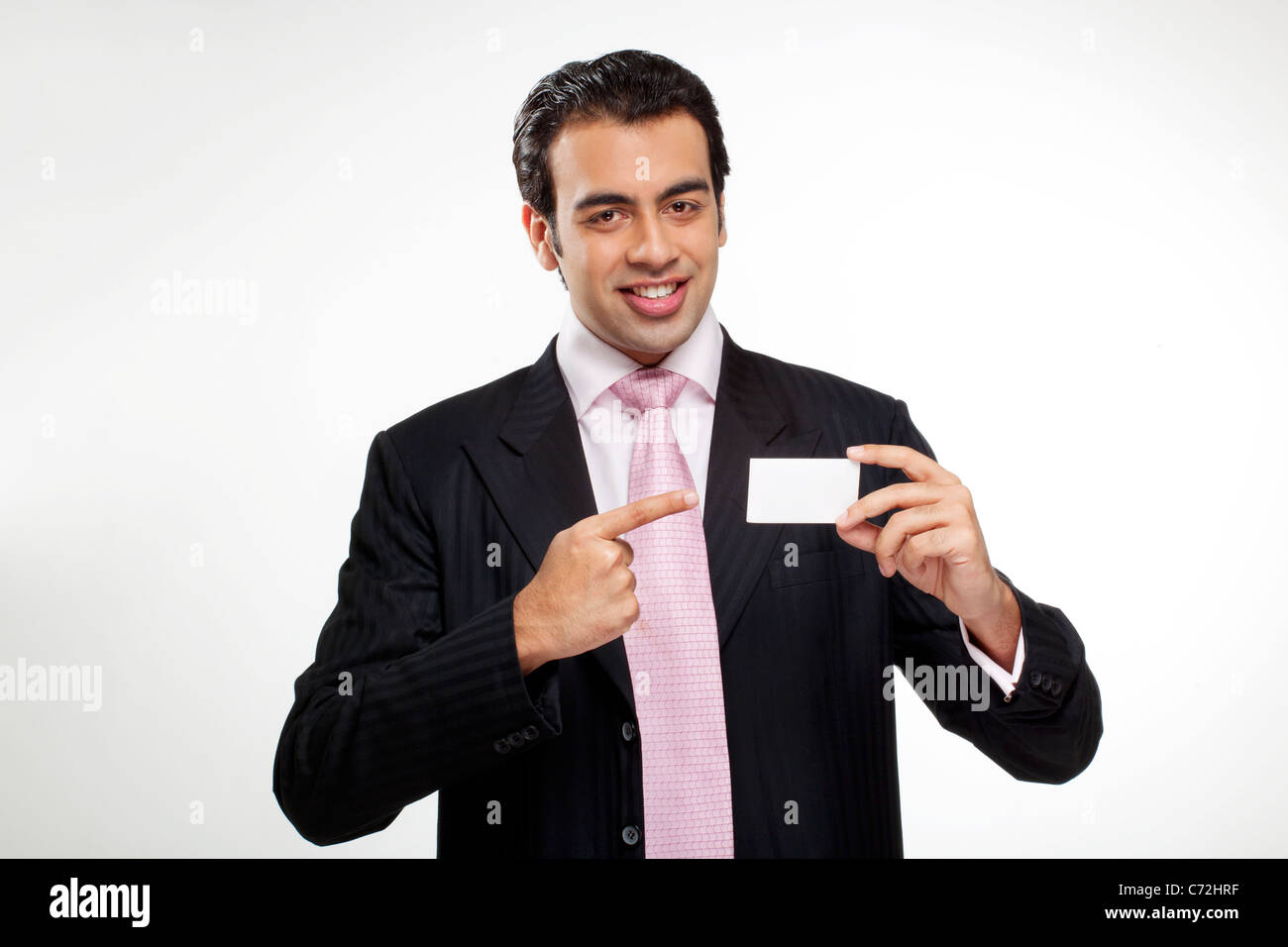 Businessman pointing to his card Stock Photo - Alamy