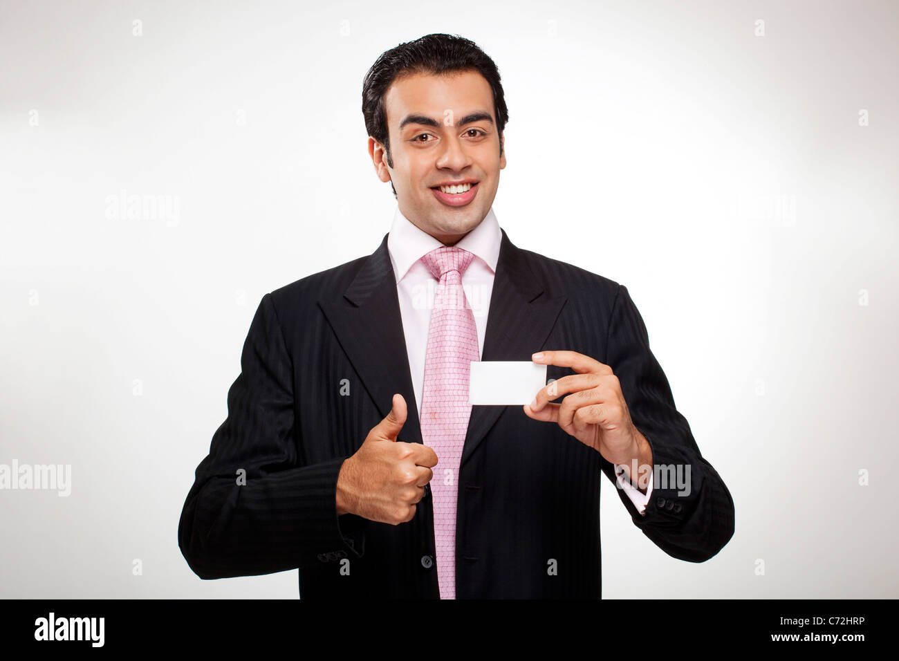 Businessman giving a thumbs up Stock Photo - Alamy
