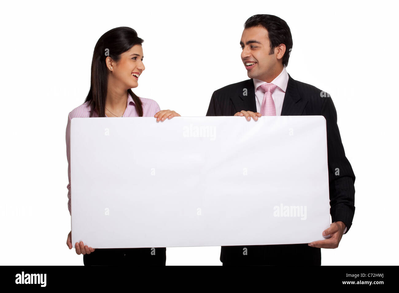 Executives holding a placard Stock Photo - Alamy
