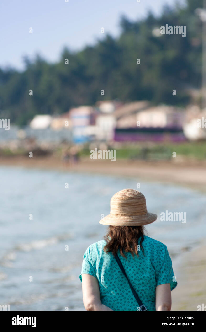 Older lady walks along the shore at Katakolon, Greece.(Model Release ...