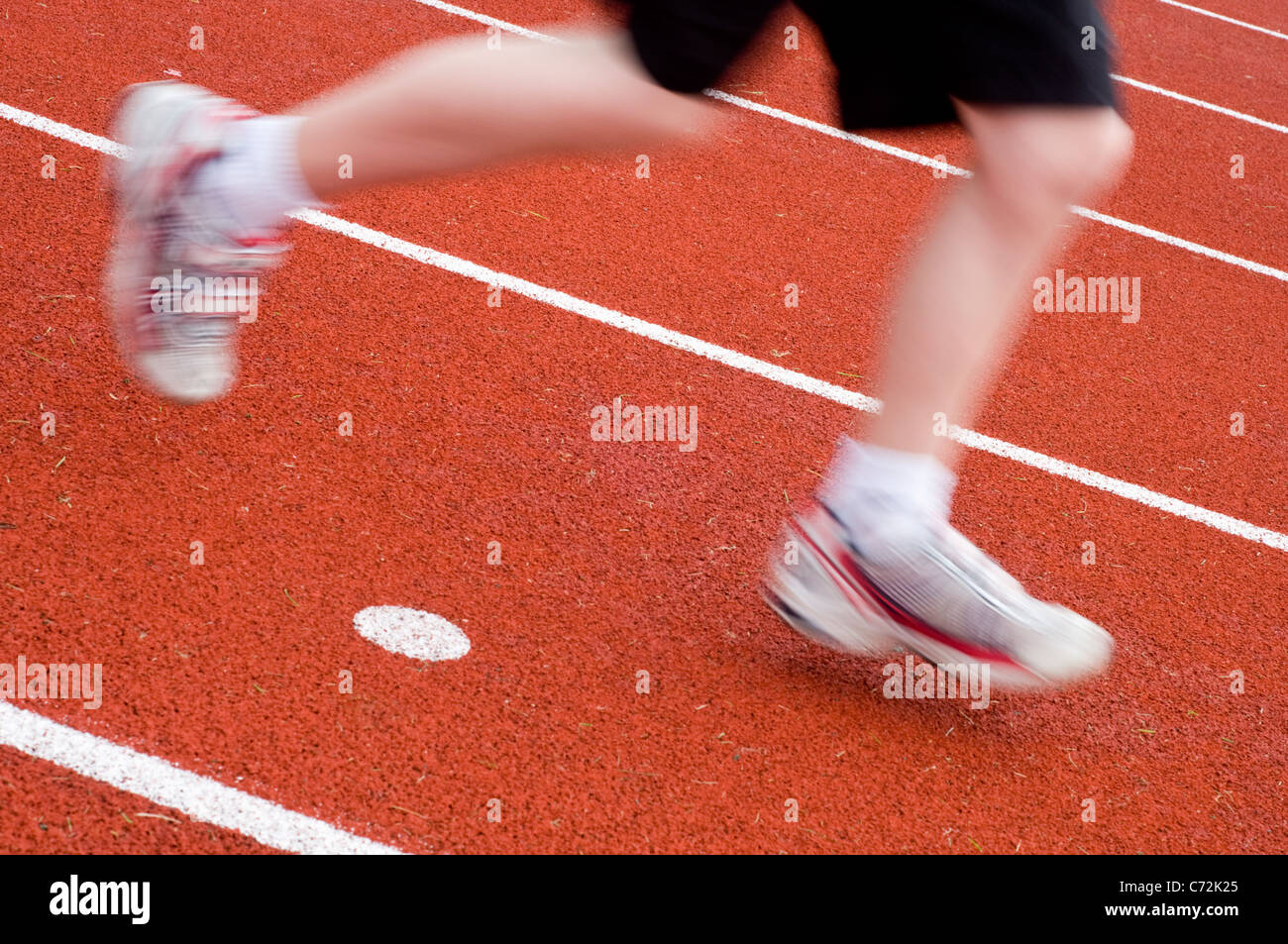 Detail of a runner on an athletics track Stock Photo - Alamy