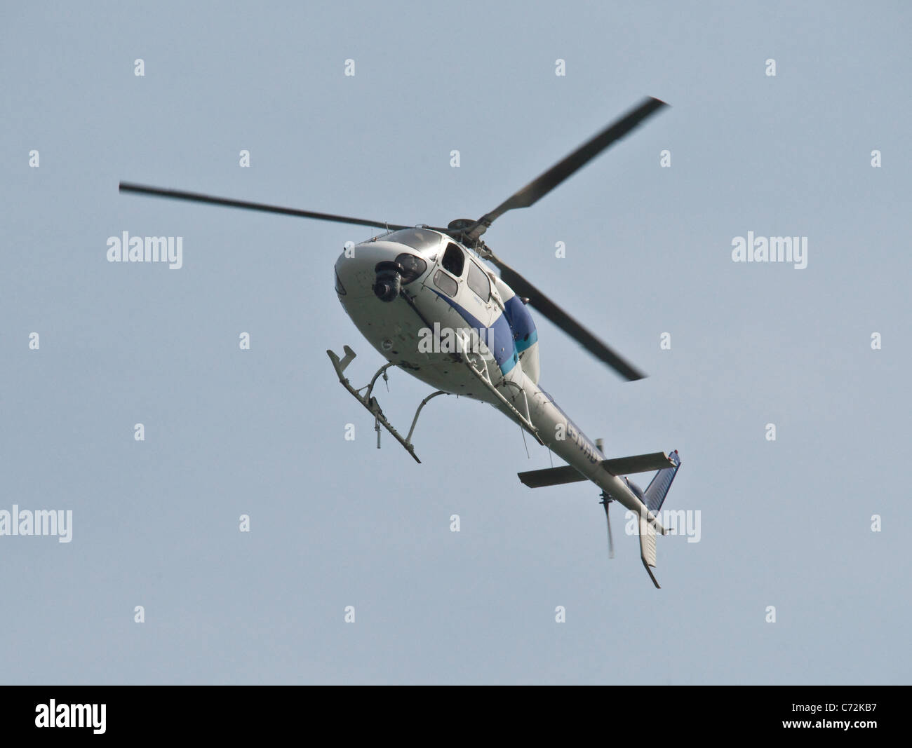 A helicopter in flight, filming from a camera fitted below the cockpit ...