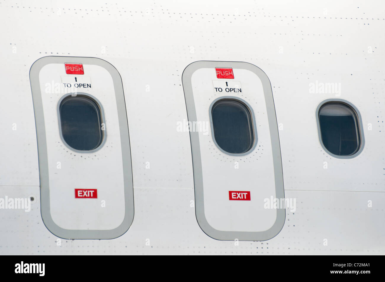 Windows of an airplane outside. White color plane. Two doors Stock ...
