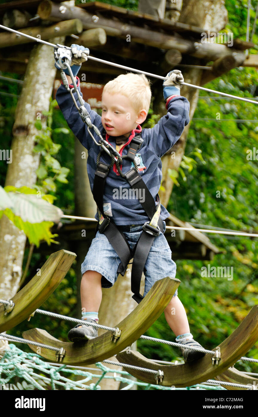 A young boy on an adventure ropes course Stock Photo - Alamy