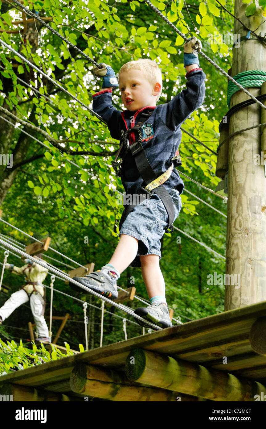 A young boy on an adventure ropes course Stock Photo - Alamy