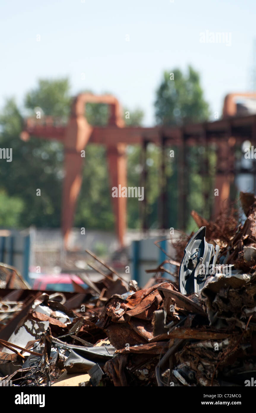 Pile of scrap iron and crane. Blurred background. Vertical image Stock ...