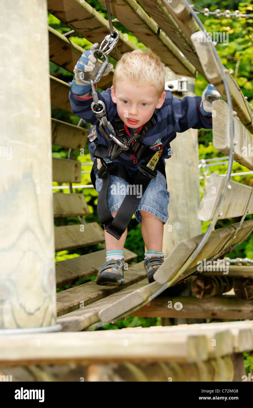 A young boy on an adventure ropes course Stock Photo - Alamy