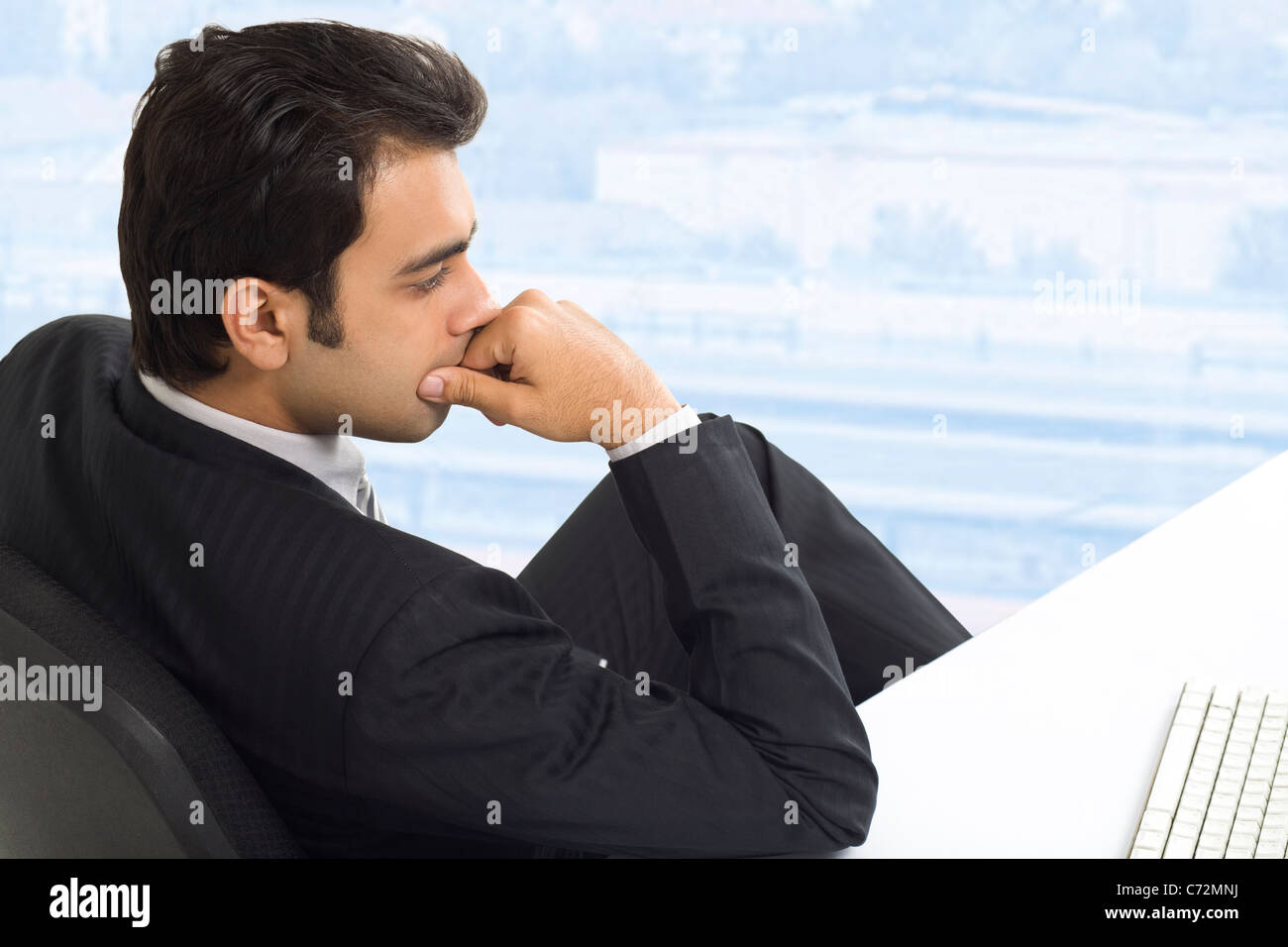Businessman looking at his computer Stock Photo - Alamy