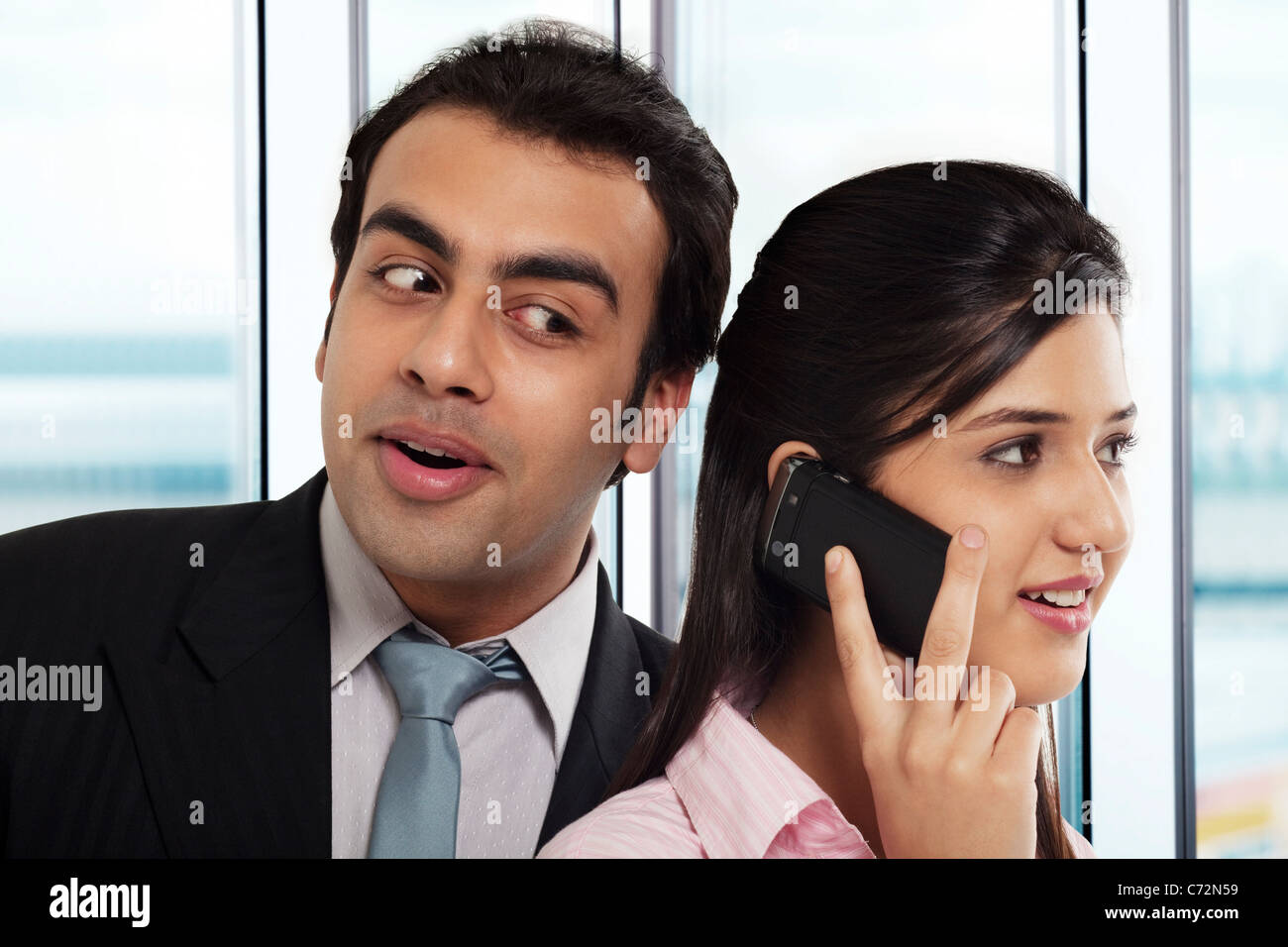 Businessman listening in on a conversation Stock Photo - Alamy