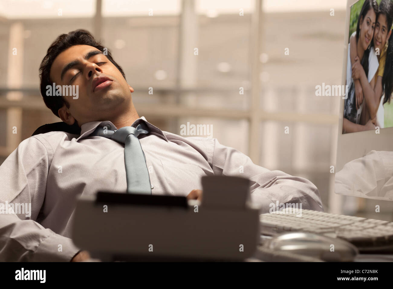 Businessman sleeping in the office Stock Photo - Alamy