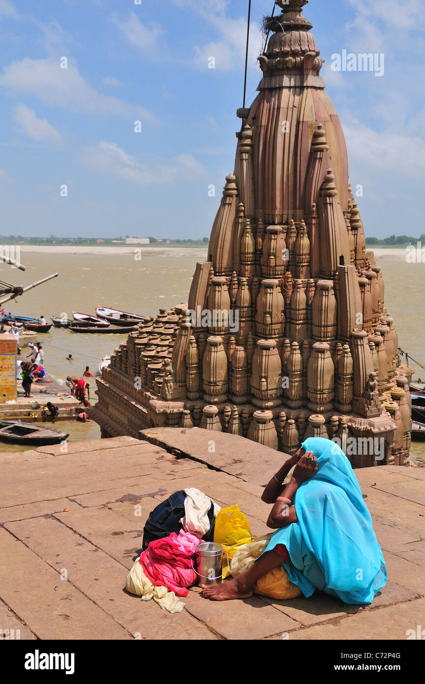 Pilgrims relaxing after bathing at the ghat by the Ganges river Stock ...