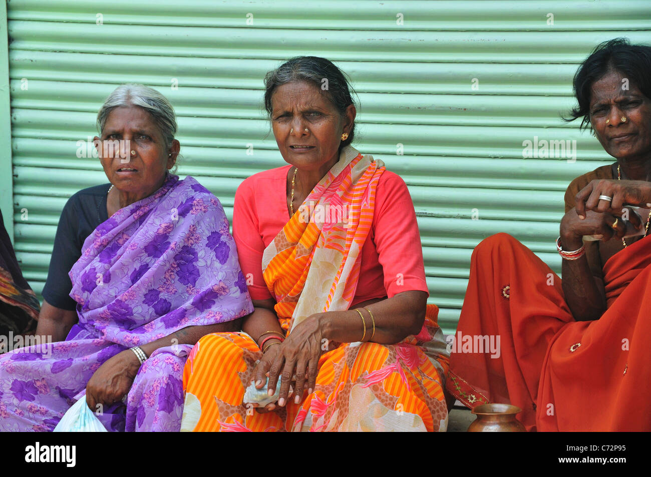 Pilgrim women having rest by the street Stock Photo - Alamy