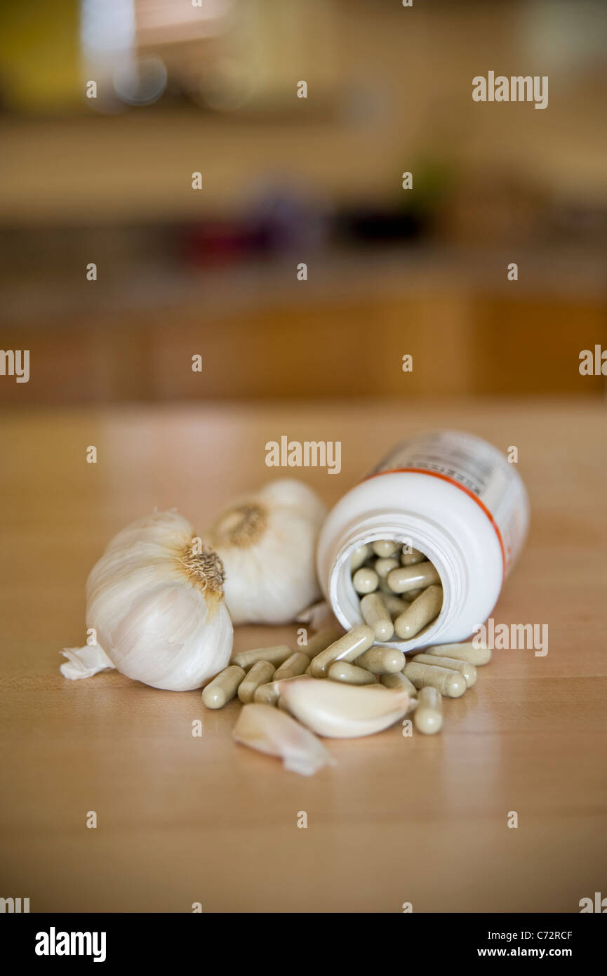 Aged Garlic capsules - in a still life arrangement with garlic cloves ...