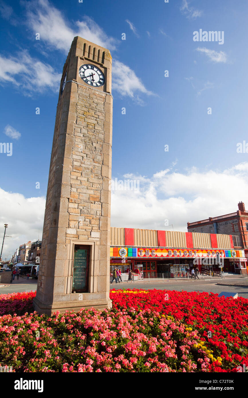 A clock tower in the middle of a roundabout on the seafront in Rhyl ...