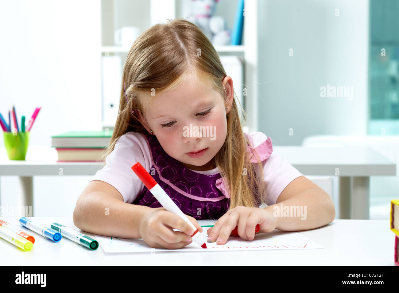 Portrait of lovely girl drawing with colorful pencils Stock Photo - Alamy