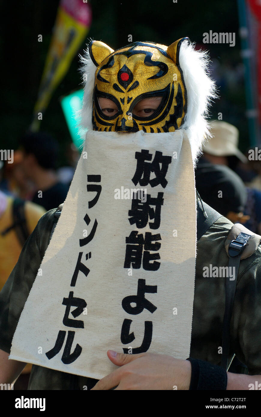 An Anti-Nuclear protester in a tiger mask attends a rally at an Anti ...