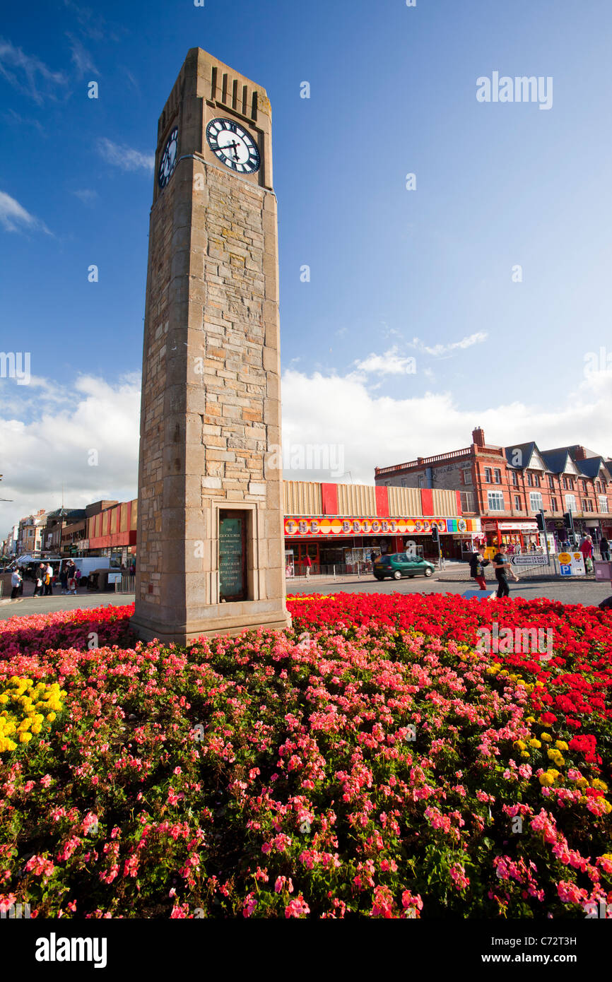 A clock tower in the middle of a roundabout on the seafront in Rhyl ...