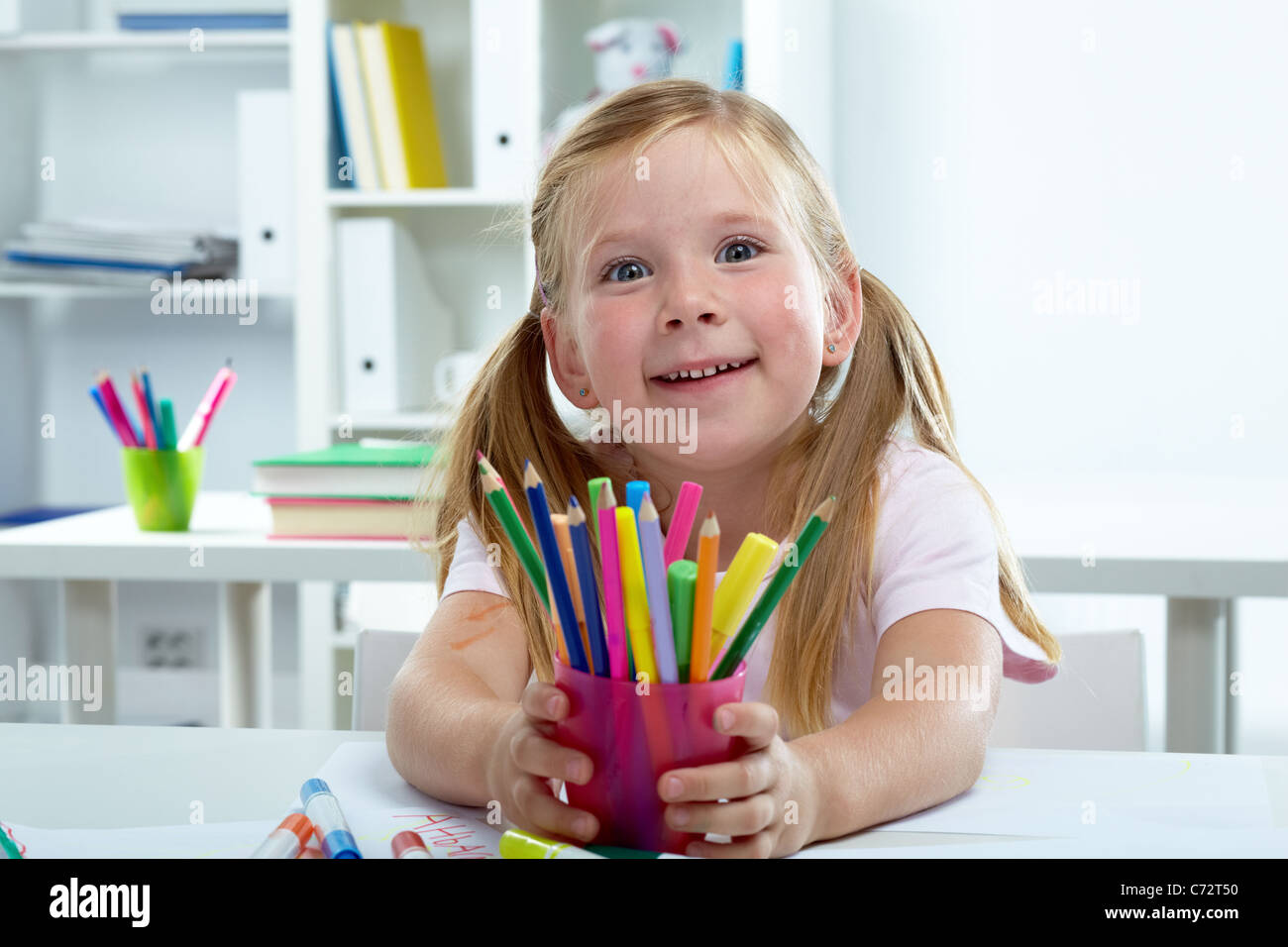 Portrait of lovely girl with colorful crayons Stock Photo - Alamy
