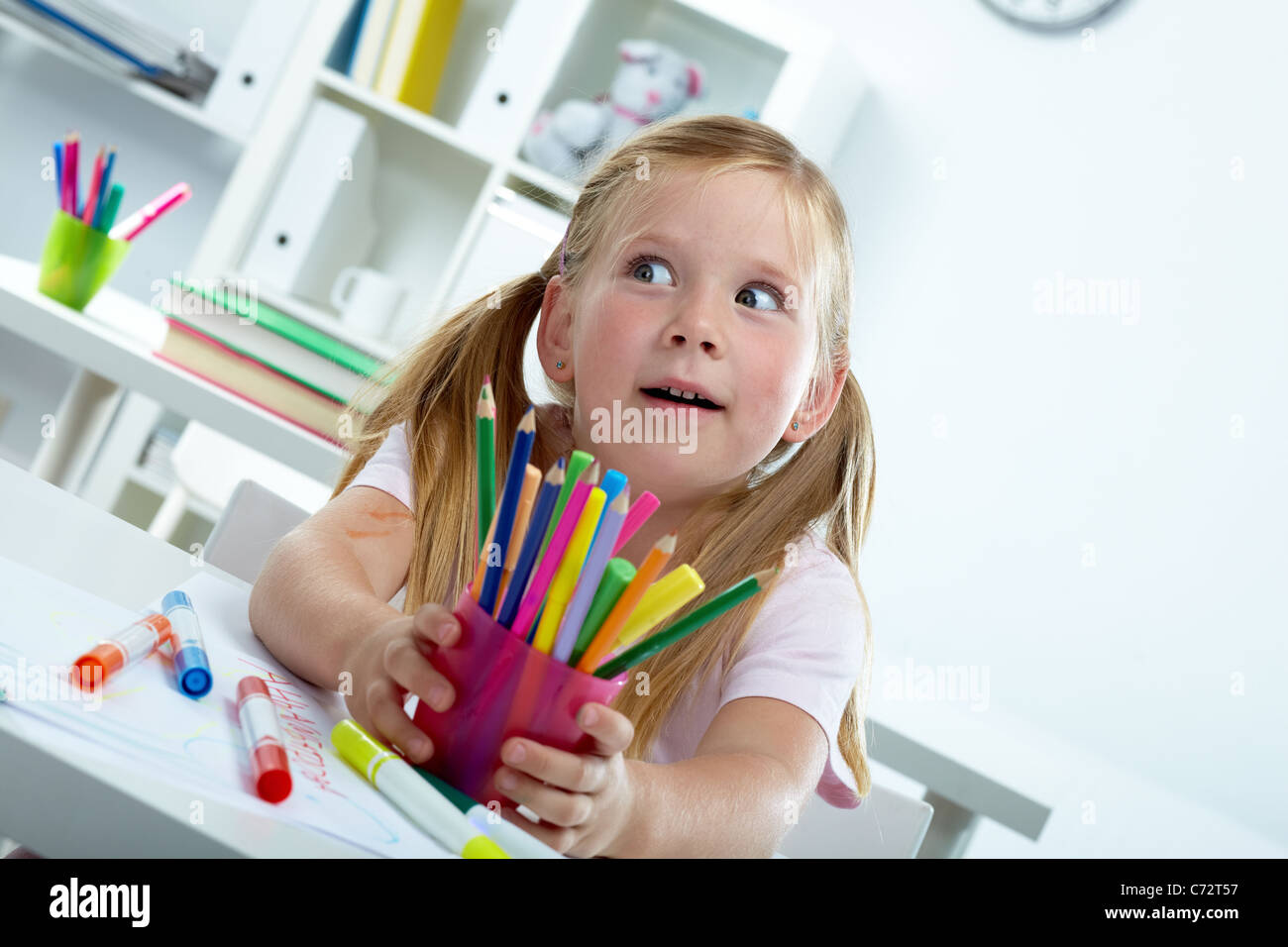 Portrait of lovely girl with colorful crayons looking aside Stock Photo ...