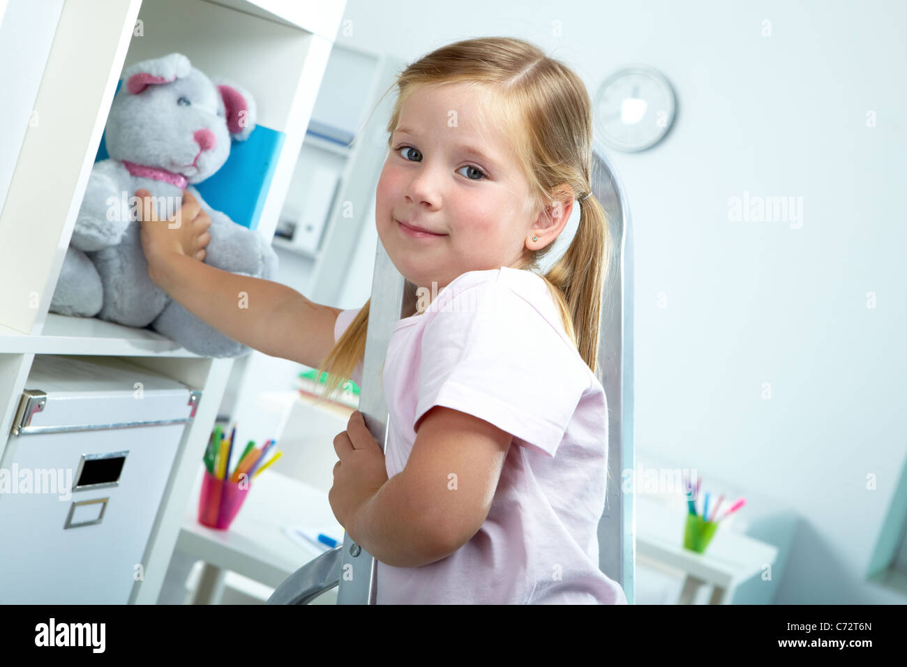 Portrait of lovely girl touching her favourite soft toy Stock Photo - Alamy