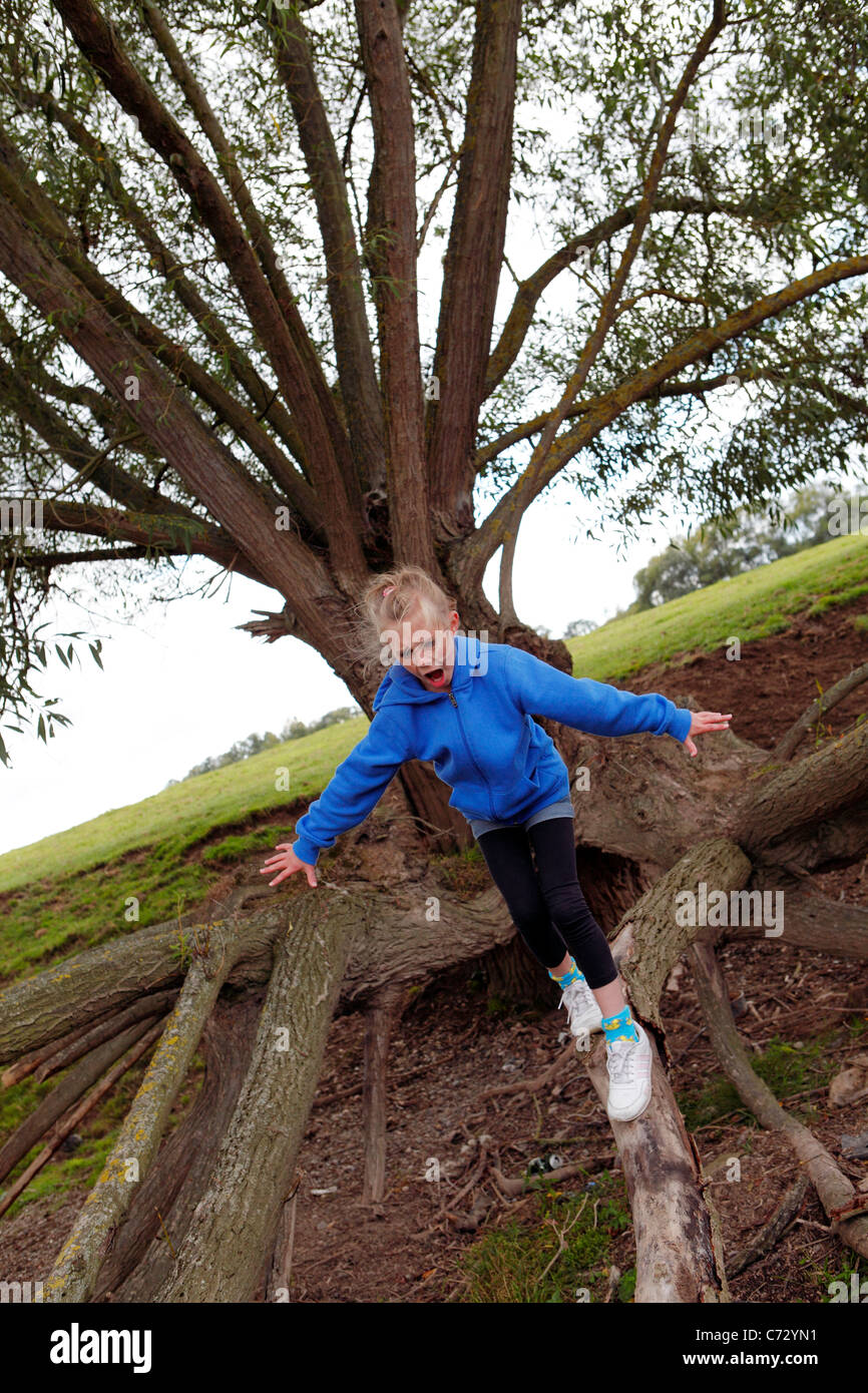 girl climbing on tree branch Stock Photo - Alamy