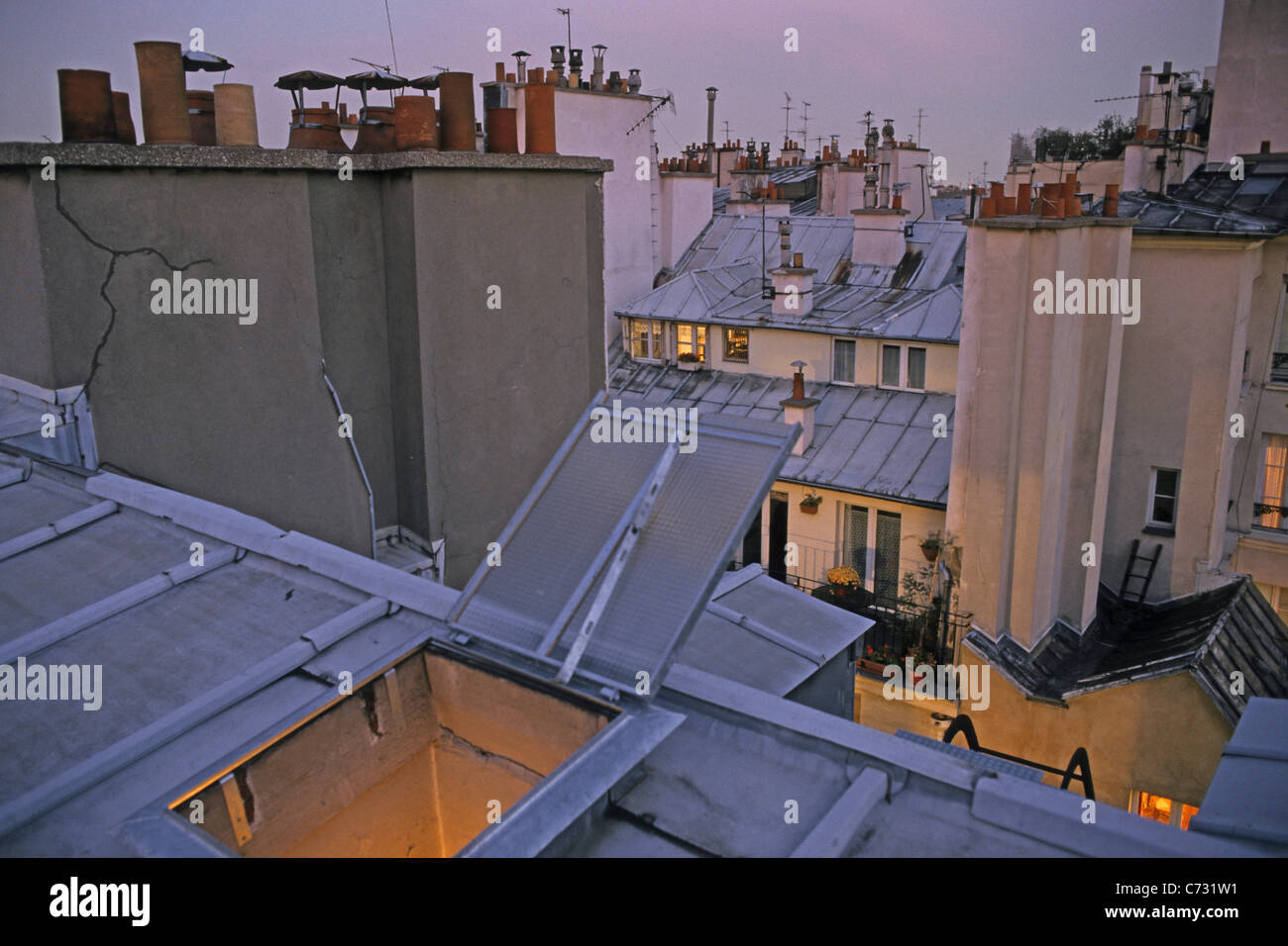 Above the rooftops of Paris in the evening light, romantic, chimneys ...