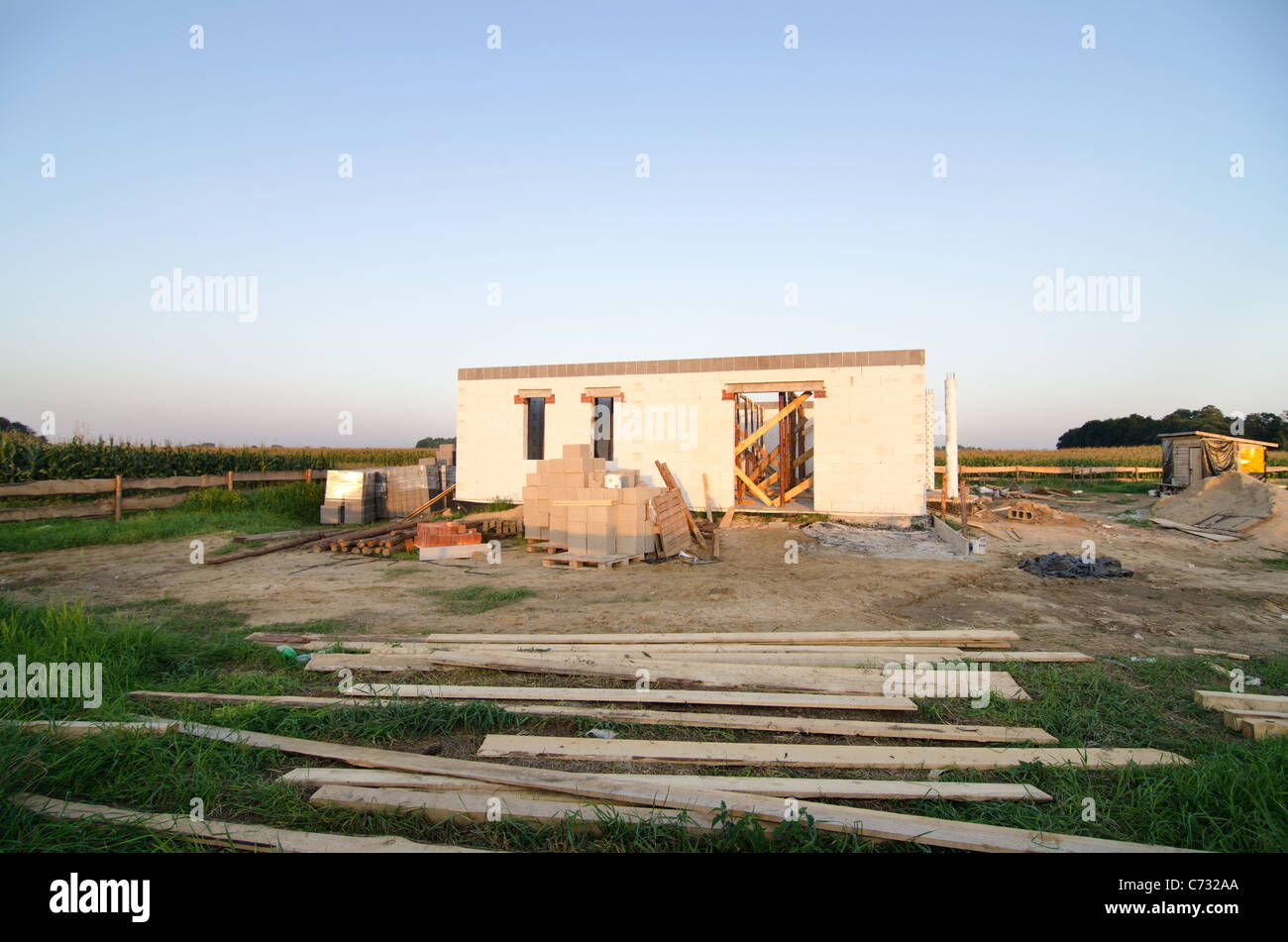 House under construction surrounded by a corn field Stock Photo - Alamy