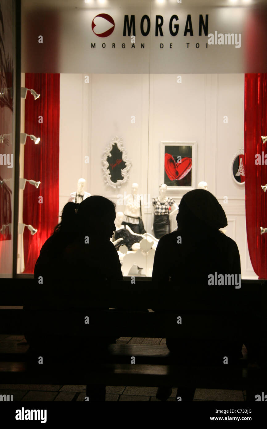 couple sitting on bench at champs elysees street in paris france Stock ...