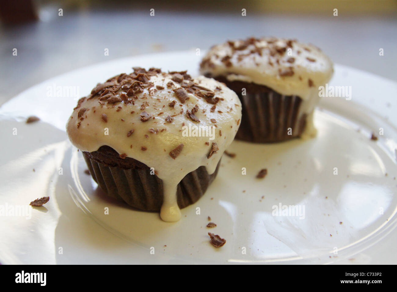 Two cupcakes on a plate Stock Photo - Alamy