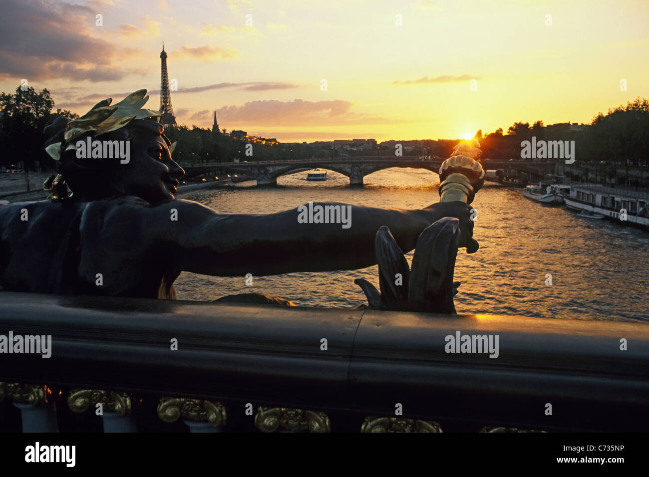 Figure at a bridge above the Seine river at sunset, view from Pont ...