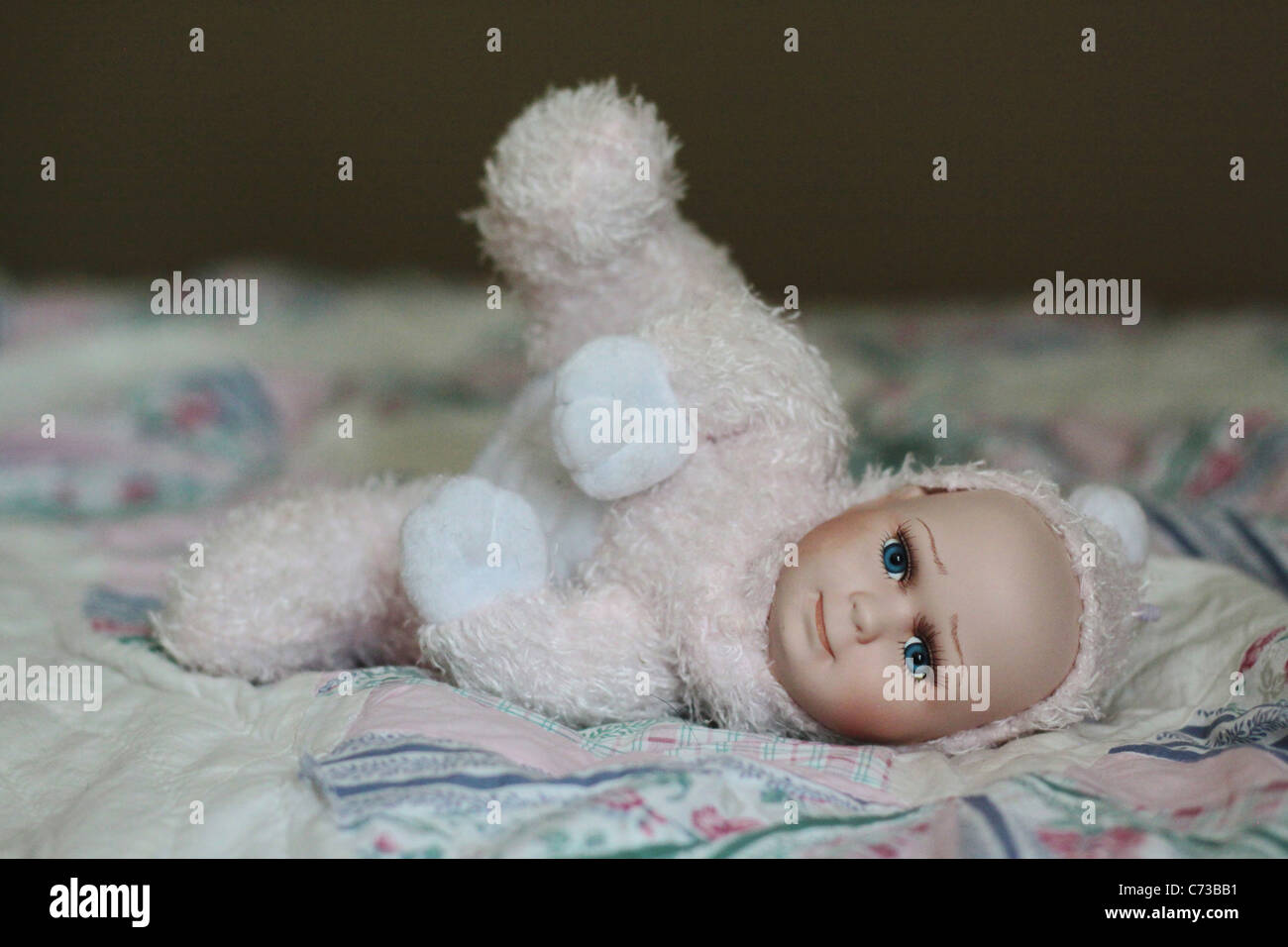 A creepy stuffed toy with a human face Stock Photo - Alamy