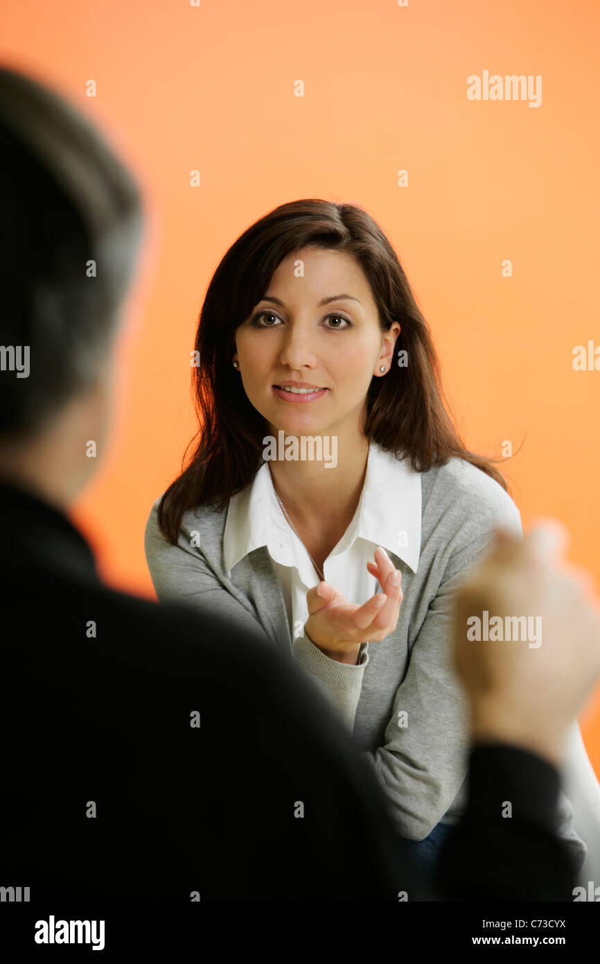 Young woman in conversation with a man Stock Photo - Alamy
