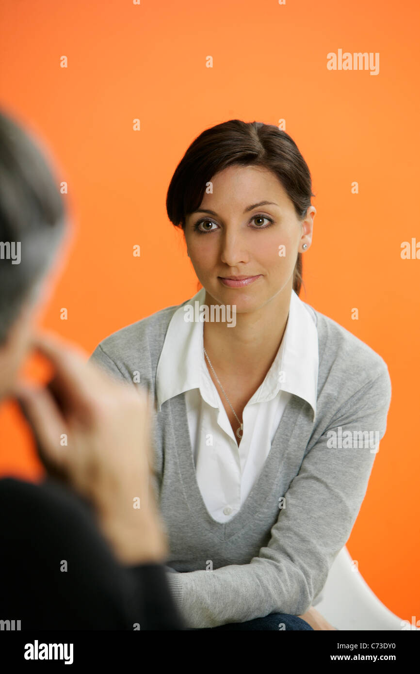 Young woman in conversation with a man Stock Photo - Alamy