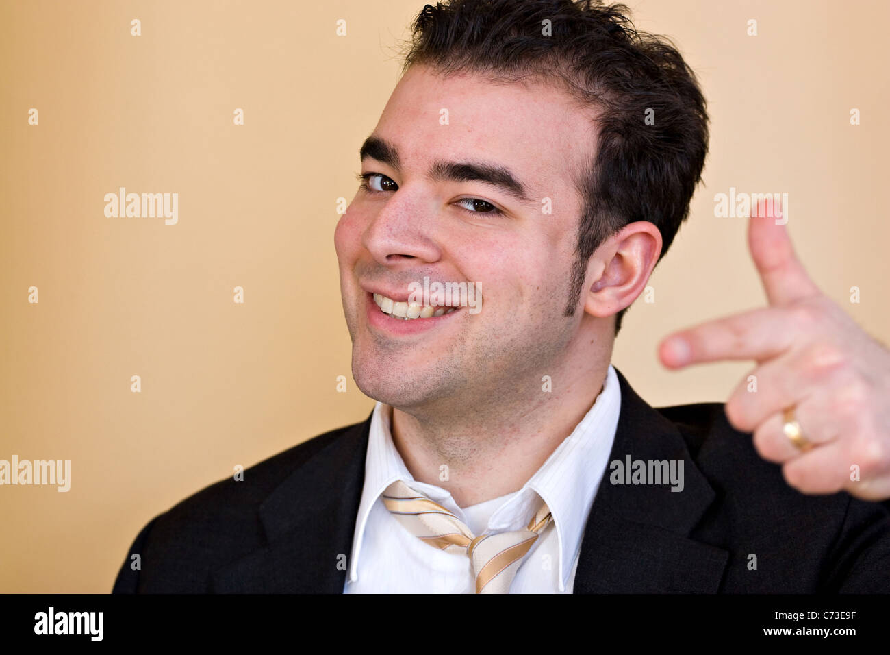 A goofy smiling business man pointing and trying to act like he is a ...