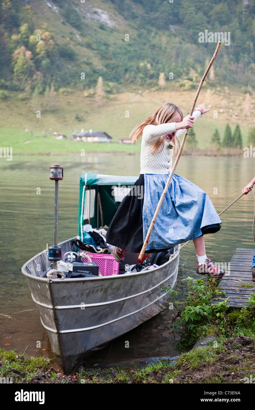 Girl getting of a boat, Konigssee, Berchtesgadener Land, Upper Bavaria ...