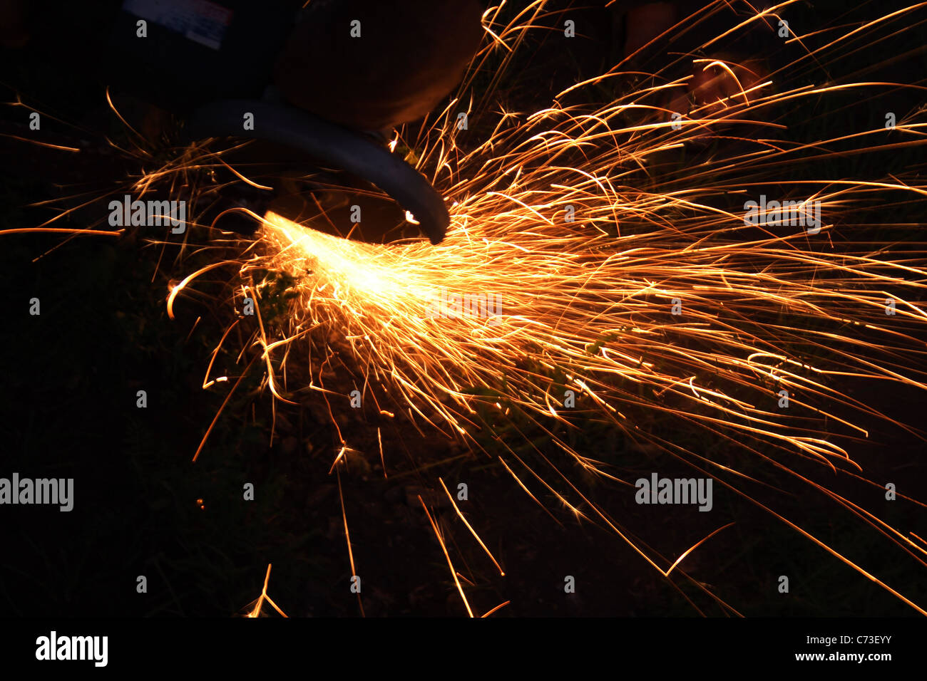 sparks fly in all directions, while cutting metal while cutting metal ...